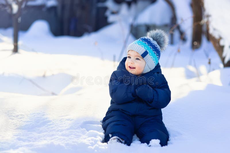 Baby boy sitting on snow stock image. Image of adorable - 138425429