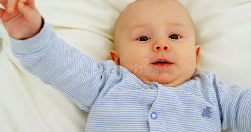 Baby Boy Smiling while Relaxing on Baby Bed at Home 4k Stock Image ...