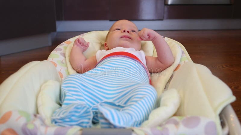 Baby Boy in a White Shirt Lying in a Cradle on the Stock Footage ...