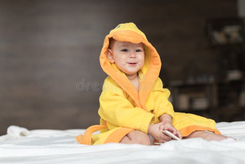 Baby boy in yellow robe stock photo. Image of indoor - 93466446