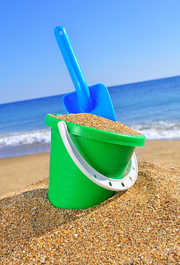 Red Bucket and Blue Spade on Sunny Sandy Beach Stock Photo - Image of ...
