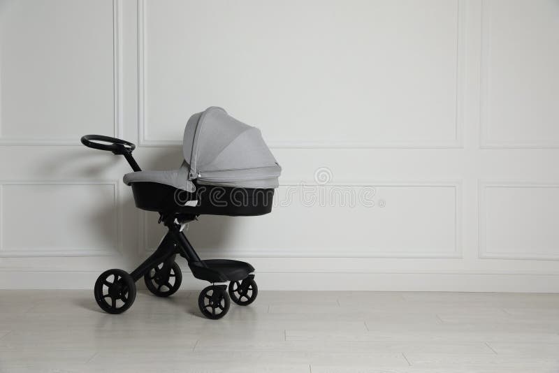 Baby Carriage. Modern Pram Near White Wall, Space for Text Stock Image ...