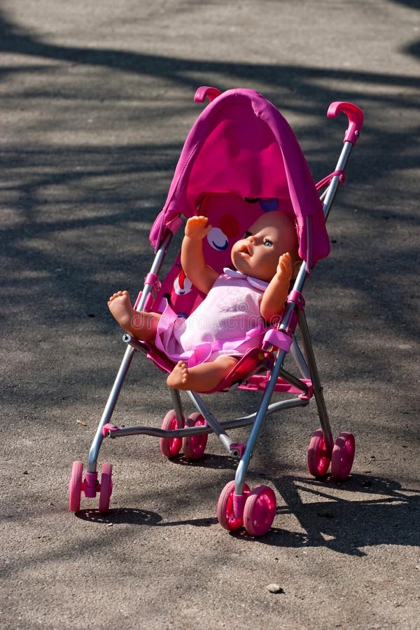 Doll in a kids baby cart stock image. Image of child - 13523583