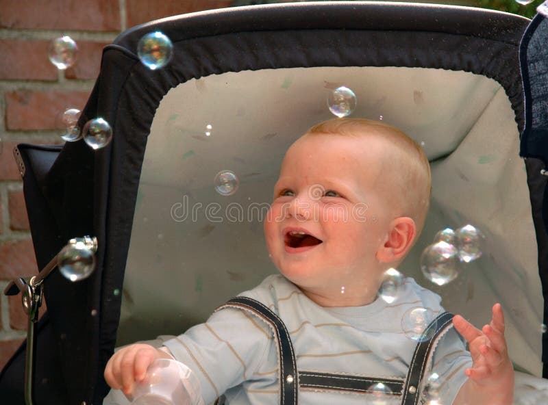 Baby Catching Bubbles stock photo. Image of baby, play - 6256746