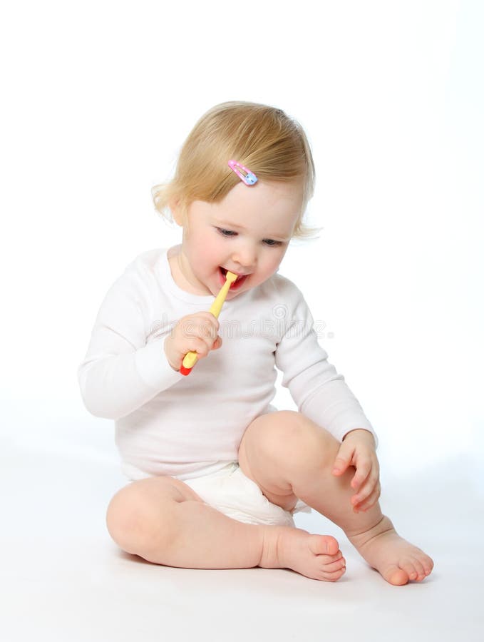 Baby cleaning one s teeth stock image. Image of front - 16974949