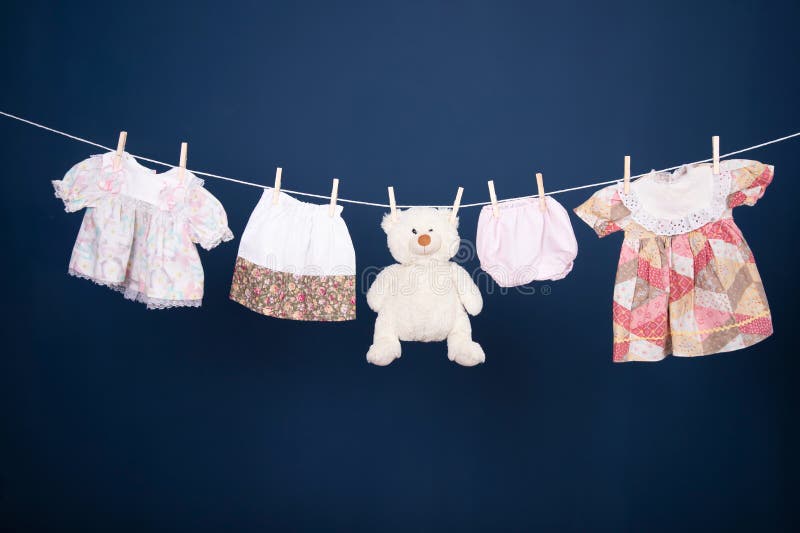 Baby Clothes Hanging on the Rope on Blue Background Stock Image - Image ...