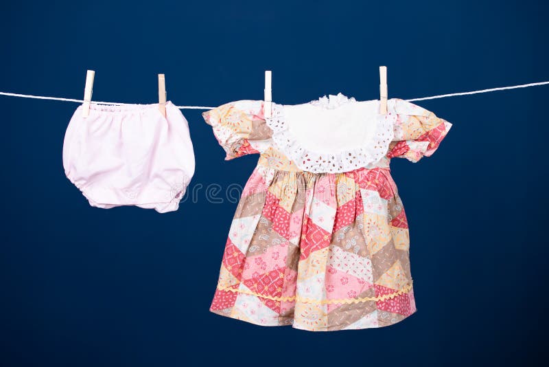 Baby Clothes Hanging on the Rope on Blue Background Stock Image - Image ...