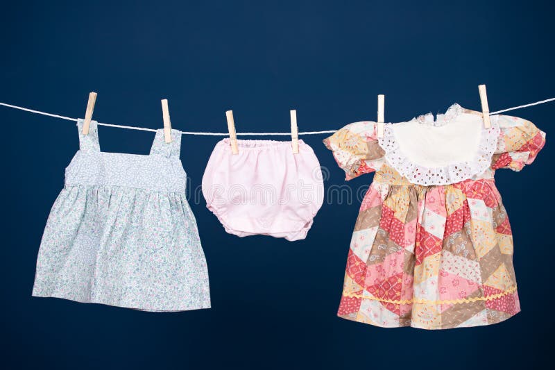 Baby Clothes Hanging on the Rope on Blue Background Stock Image - Image ...