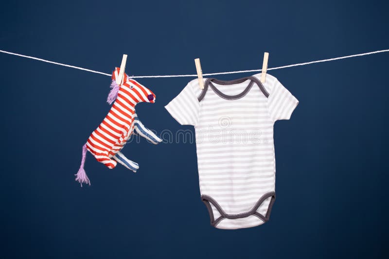 Baby Clothes Hanging on the Rope on Blue Background Stock Photo - Image ...