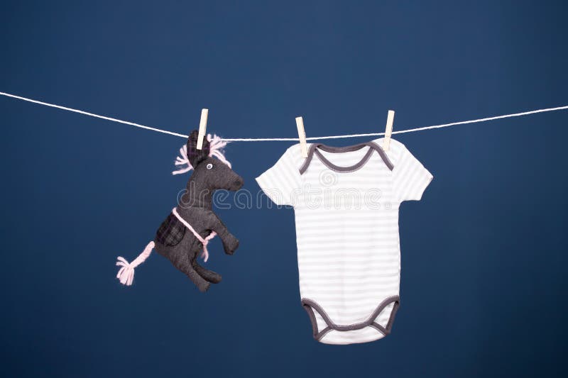 Baby Clothes Hanging on the Rope on Blue Background Stock Photo - Image ...