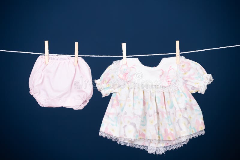 Baby Clothes Hanging on the Rope on Blue Background Stock Photo - Image ...