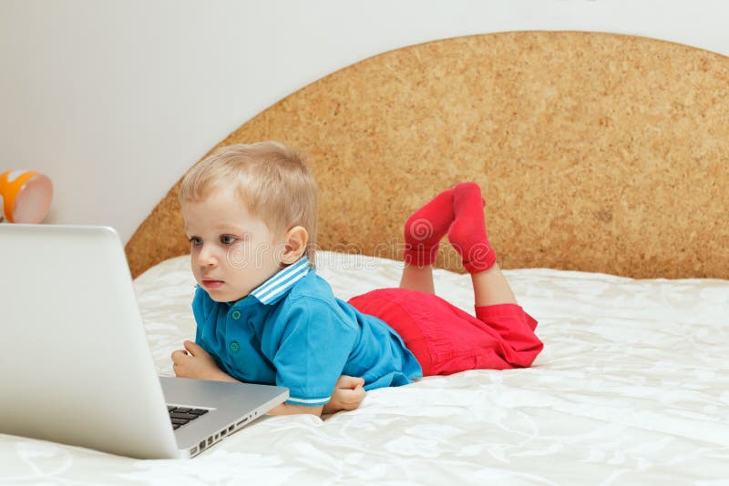 Baby with computer at home stock image. Image of play - 29433411