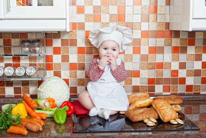 Baby Cook Girl Wearing Chef Hat with Fresh Vegetables and Fruits. Stock ...