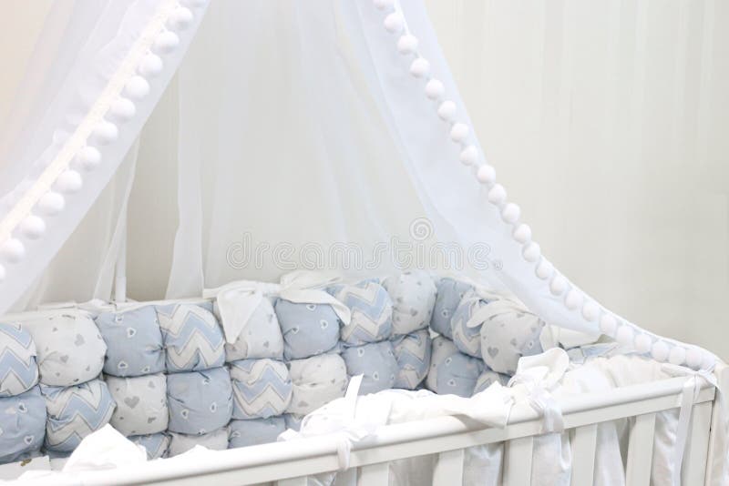 Baby Cot with Beautiful Blue Textiles. Canopy and White Crib Stock ...