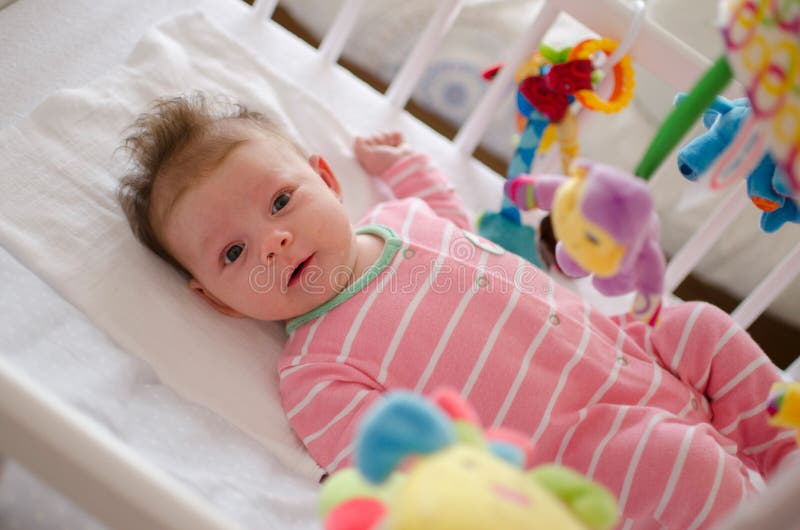 Baby in a cot stock photo. Image of colorful, furniture - 67272862