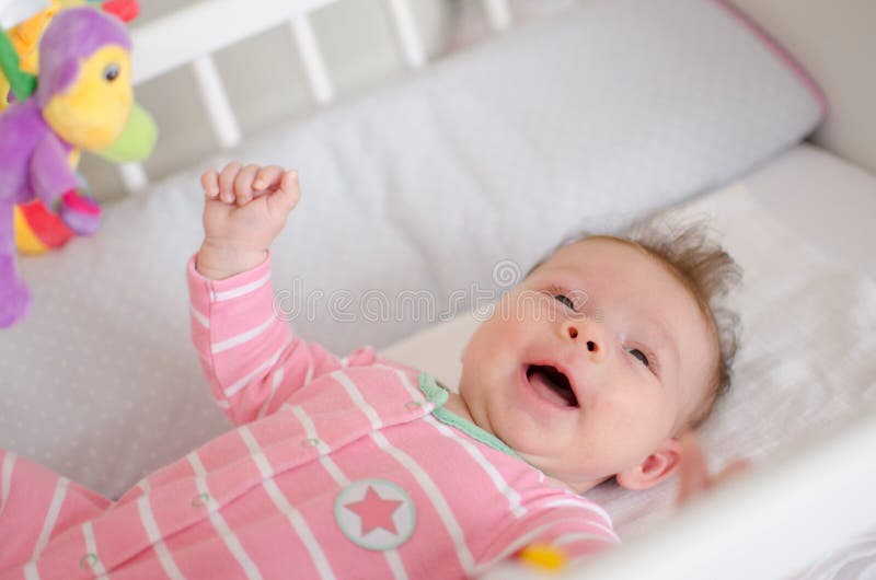 Baby in a cot stock photo. Image of wooden, newborn, smile - 67273518