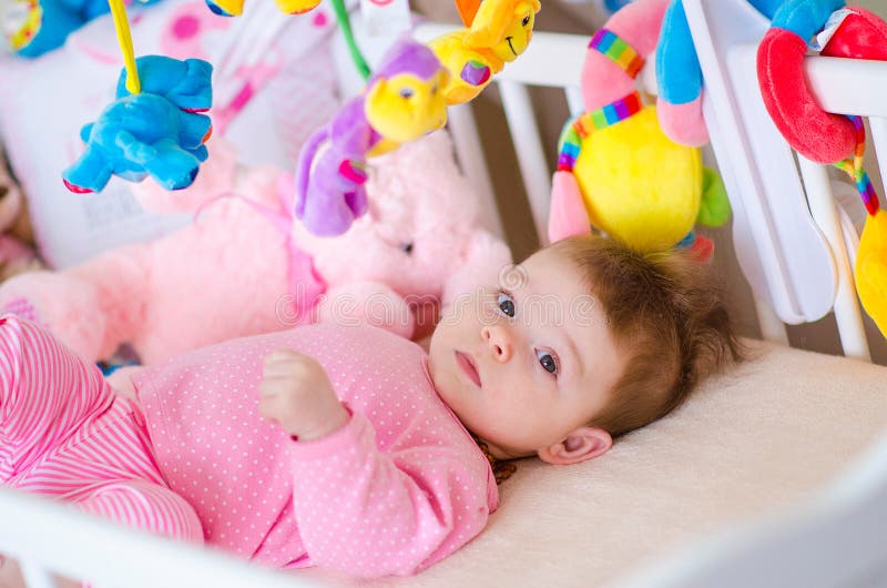 Baby in a cot stock photo. Image of infant, eyes, months - 76672594