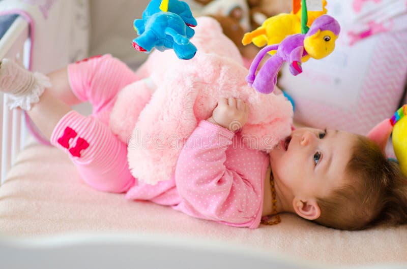 Baby in a cot stock photo. Image of wooden, infant, furniture - 76672632