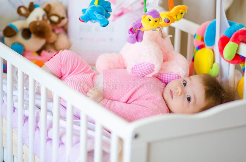 Baby in a cot stock image. Image of newborn, smile, wooden - 76672779