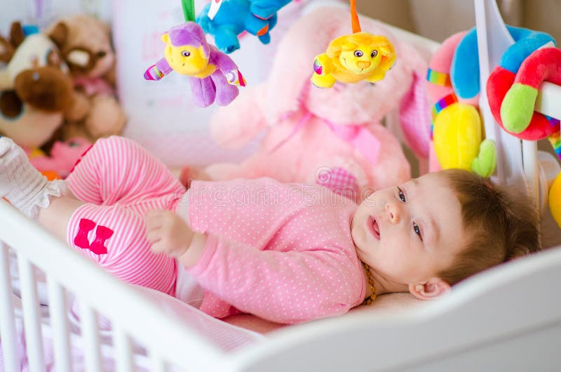 Baby in a cot stock photo. Image of colorful, smile, looking - 76672782