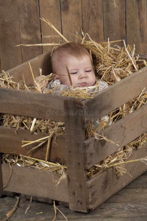 Baby in crate with straw stock photo. Image of weathered - 27036976