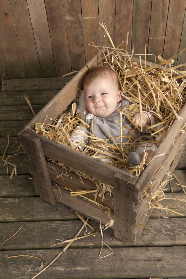 Baby in crate with straw stock image. Image of weathered - 27036981