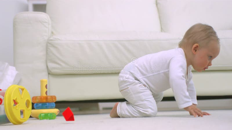 Baby crawling on the floor stock video. Video of household - 43246205