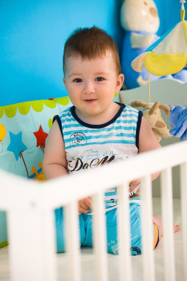 Baby on crib at home stock image. Image of colorful, cheerful - 7627925