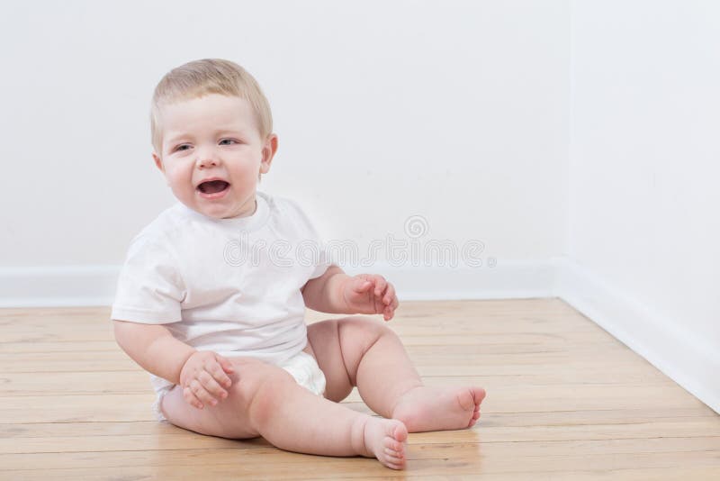 Baby Crying Sitting on Wooden Floor Stock Photo - Image of infant ...