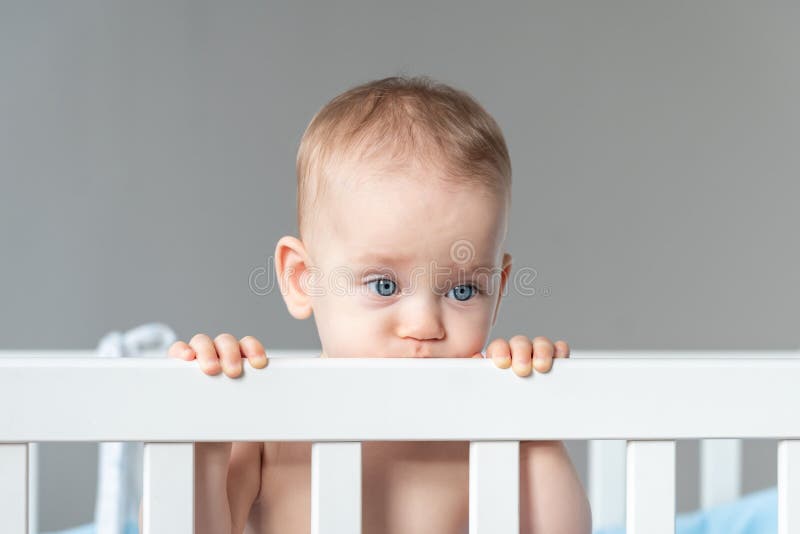 Baby Cutely Bit the Back of a Wooden Crib Stock Image - Image of ...