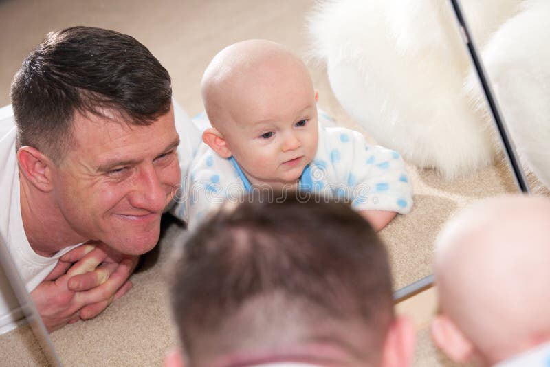 Baby and Dad Looking in Mirror Stock Photo - Image of play, laughing ...