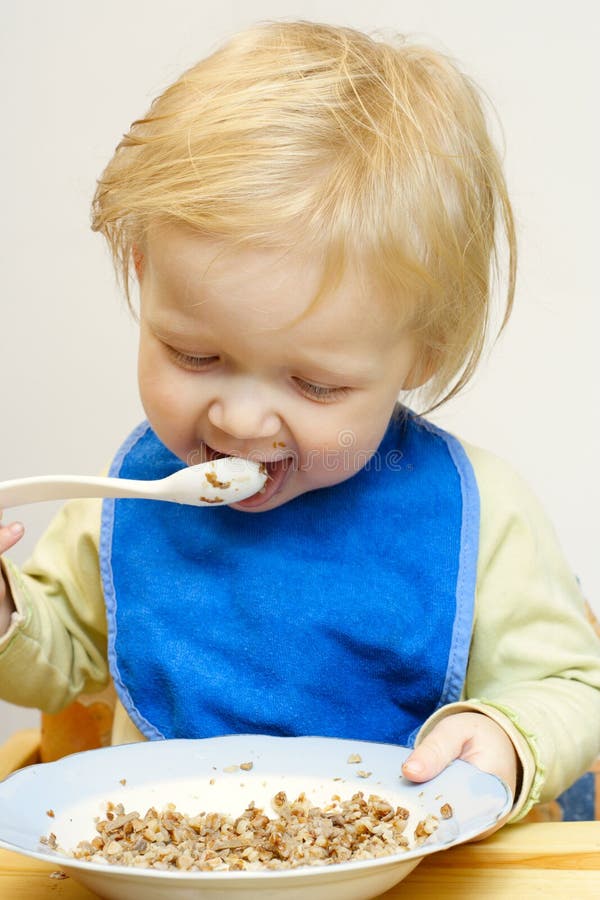 Baby eating stock image. Image of happiness, eating, shoulders - 12795049