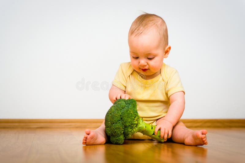 Baby eating broccoli stock image. Image of little, calabresse - 65986195