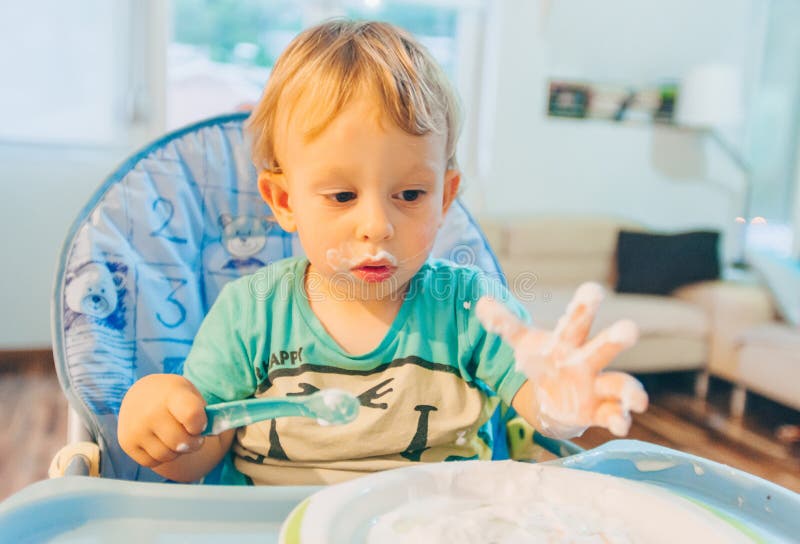 Baby eating food stock photo. Image of indoors, happiness - 151547090