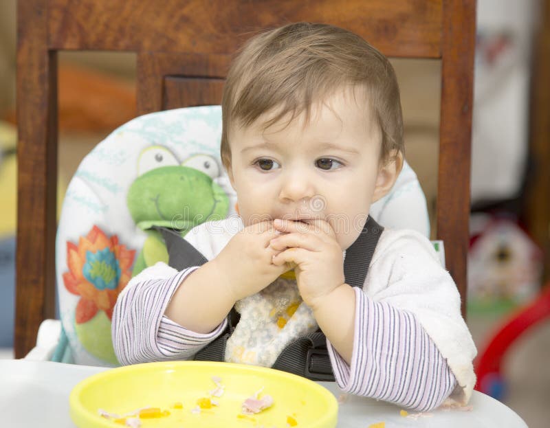Baby eating with hands stock image. Image of dirty, away - 71680805