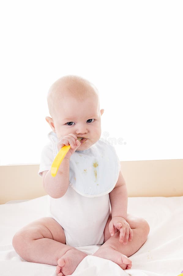 Baby eating with spoon. stock photo. Image of nutrition - 59933454