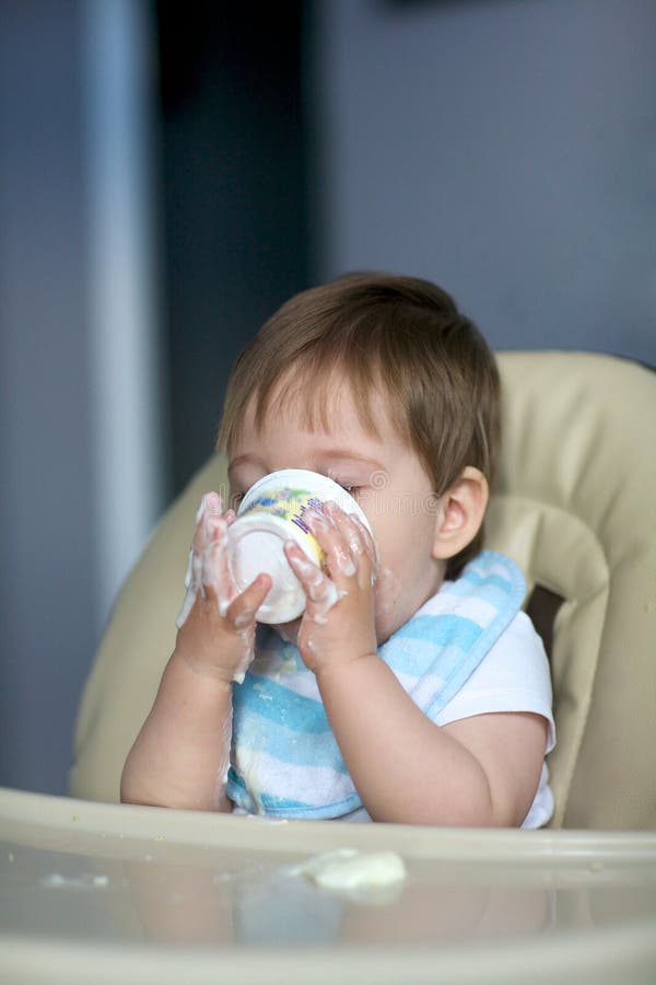 Baby eating yogurt stock image. Image of cream, dairy - 22640789