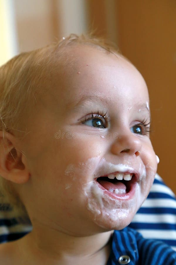 Baby eating yogurt stock image. Image of food, hungry - 63892423