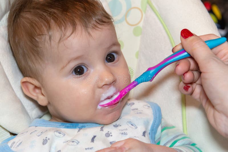 The Baby Eats Solid Food for the First Time Stock Image - Image of ...