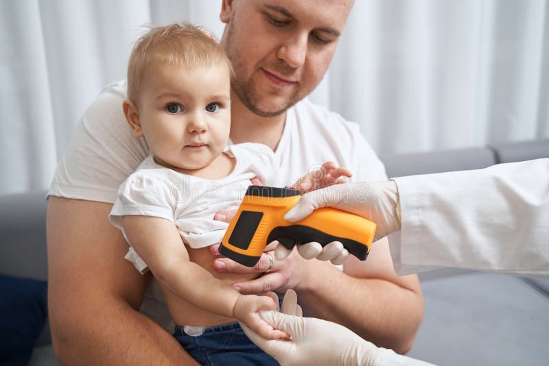 Medic Using Non-contact Thermometers on Child Hand Stock Image - Image ...