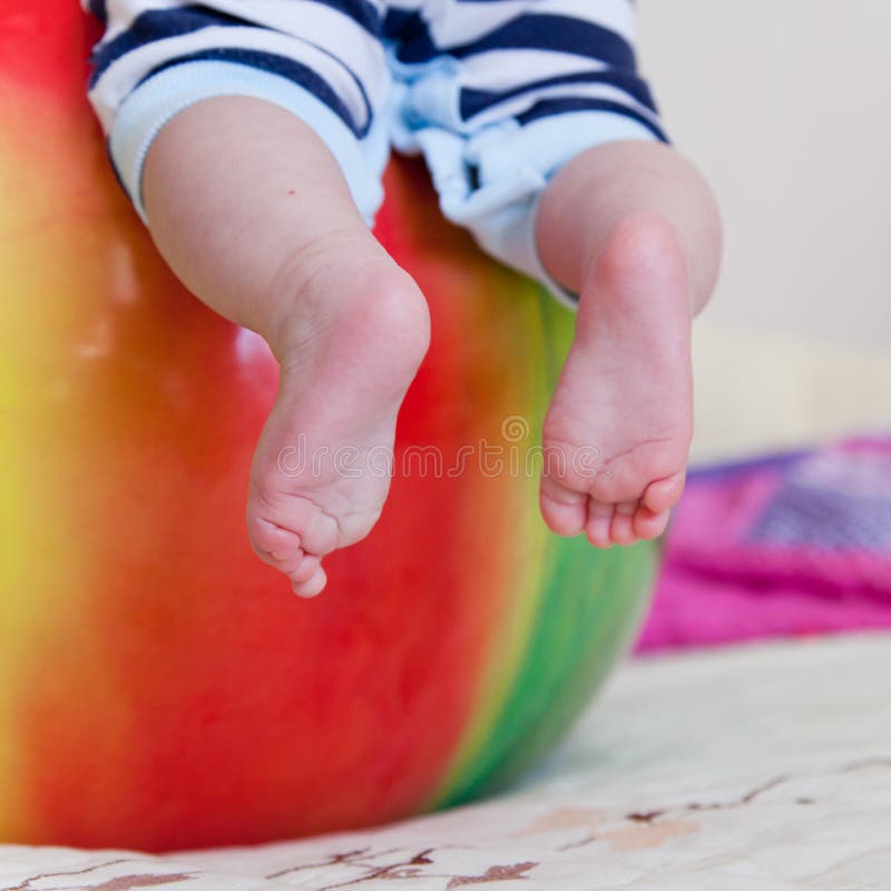 Baby feet on the ball stock image. Image of ball, childhood - 212204115