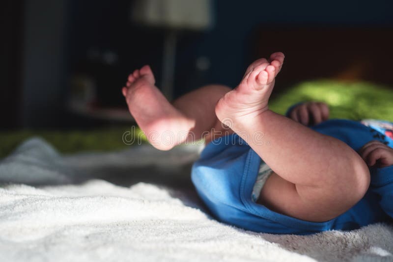 Baby feet in sunset light stock photo. Image of life - 79819972