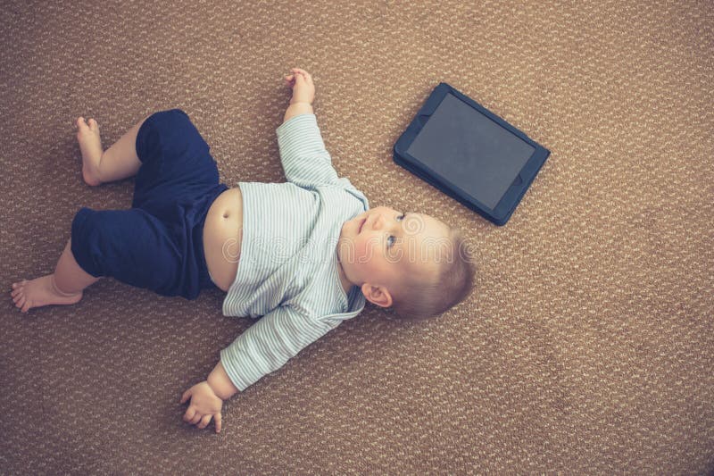 Baby on the Floor with Tablet Computer Stock Photo - Image of floor ...