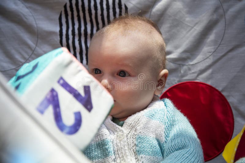 A Baby Focused on a Sensory Development Activity Playmat Stock Photo ...