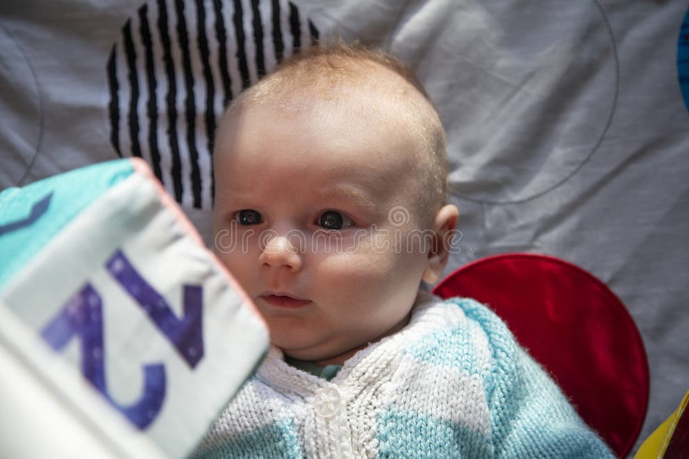 A Baby Focused on a Sensory Development Activity Playmat Stock Image ...