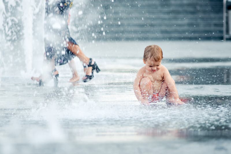 Baby in the fountain stock photo. Image of child, happiness - 69115000