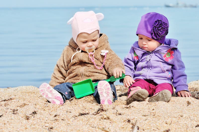 Baby Friends on the Sea Shore Stock Photo - Image of portrait, baby ...