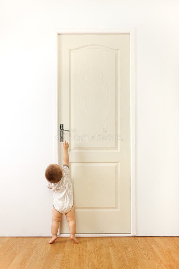 Baby in front of door stock image. Image of curiosity - 16407219