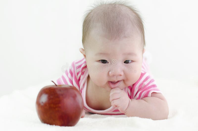 Baby girl with an apple stock photo. Image of asian, diversity - 19717820