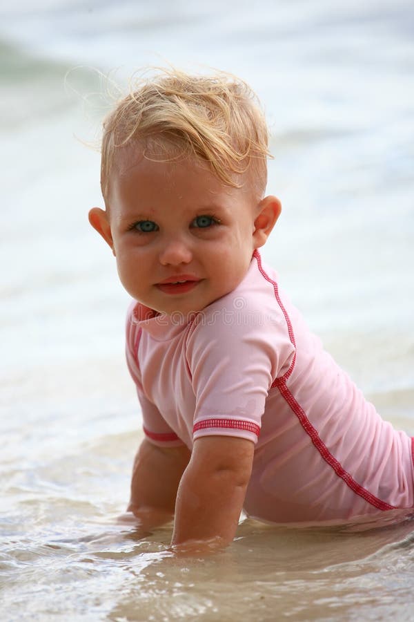 Baby girl at the beach stock photo. Image of young, hair - 12586608